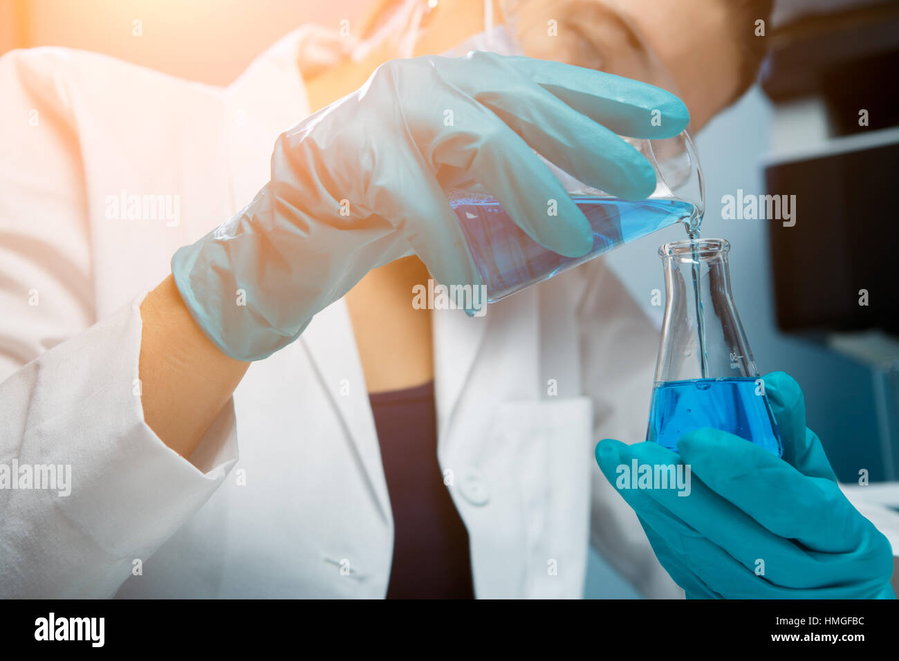 Woman spends experiments with flask in chemistry lab Stock Photo - Alamy