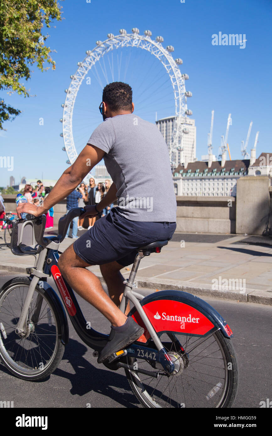 male cyclist on Santander hire bike riding on east-west cycle ...