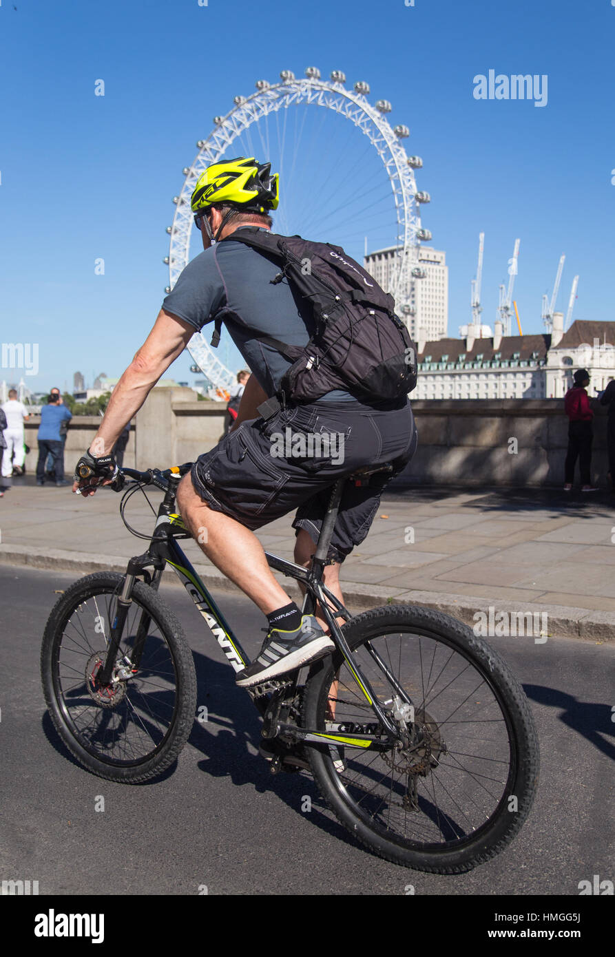middle-aged male cyclist riding on east-west cycle superhighway with ...