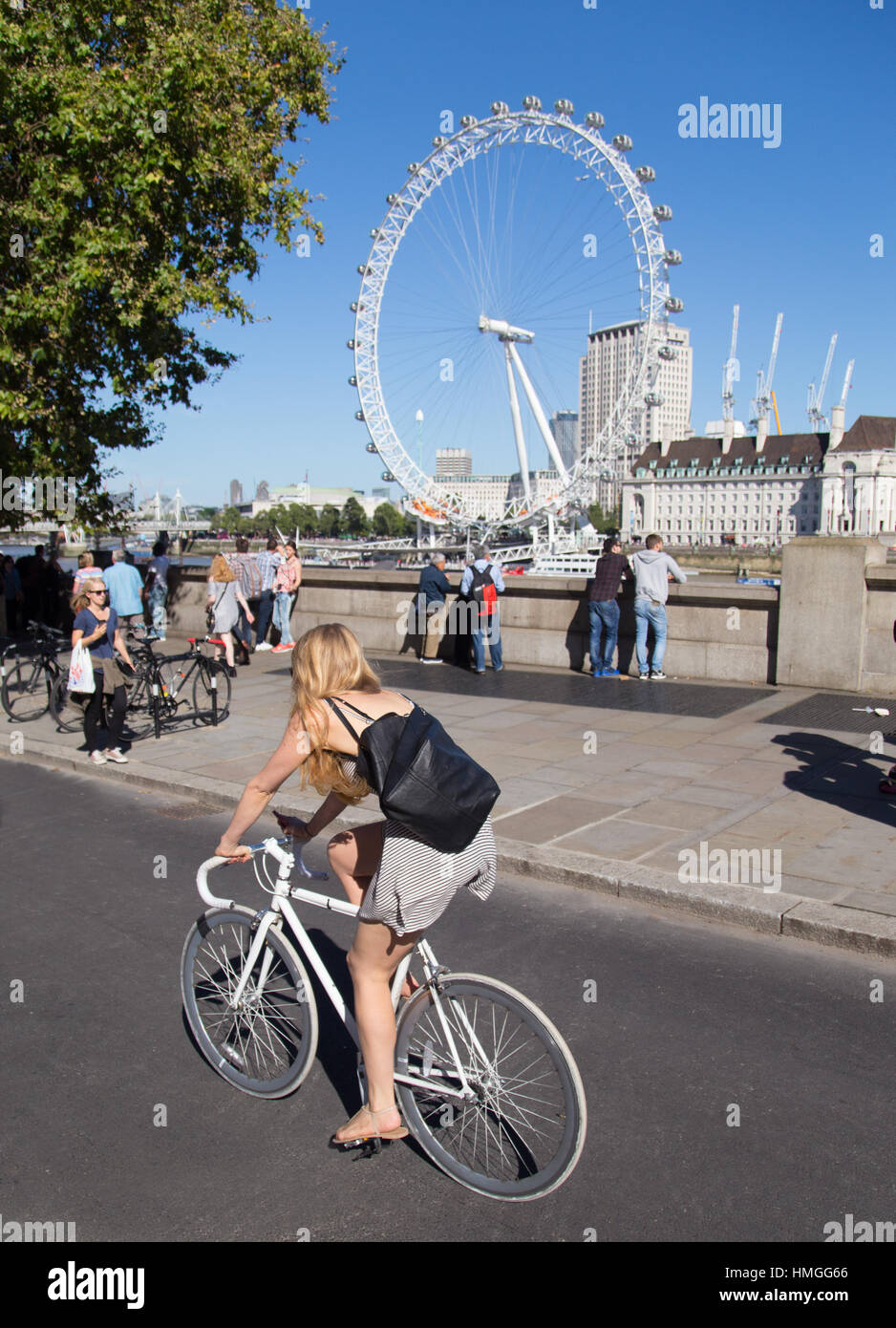 young blonde-haired woman riding road bike on east-west cycle ...
