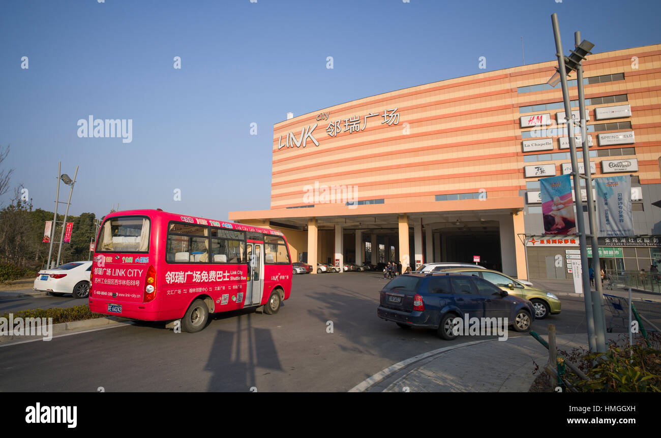 Shuttle (mini-)bus an d cars parked outside Link City shopping centre ...