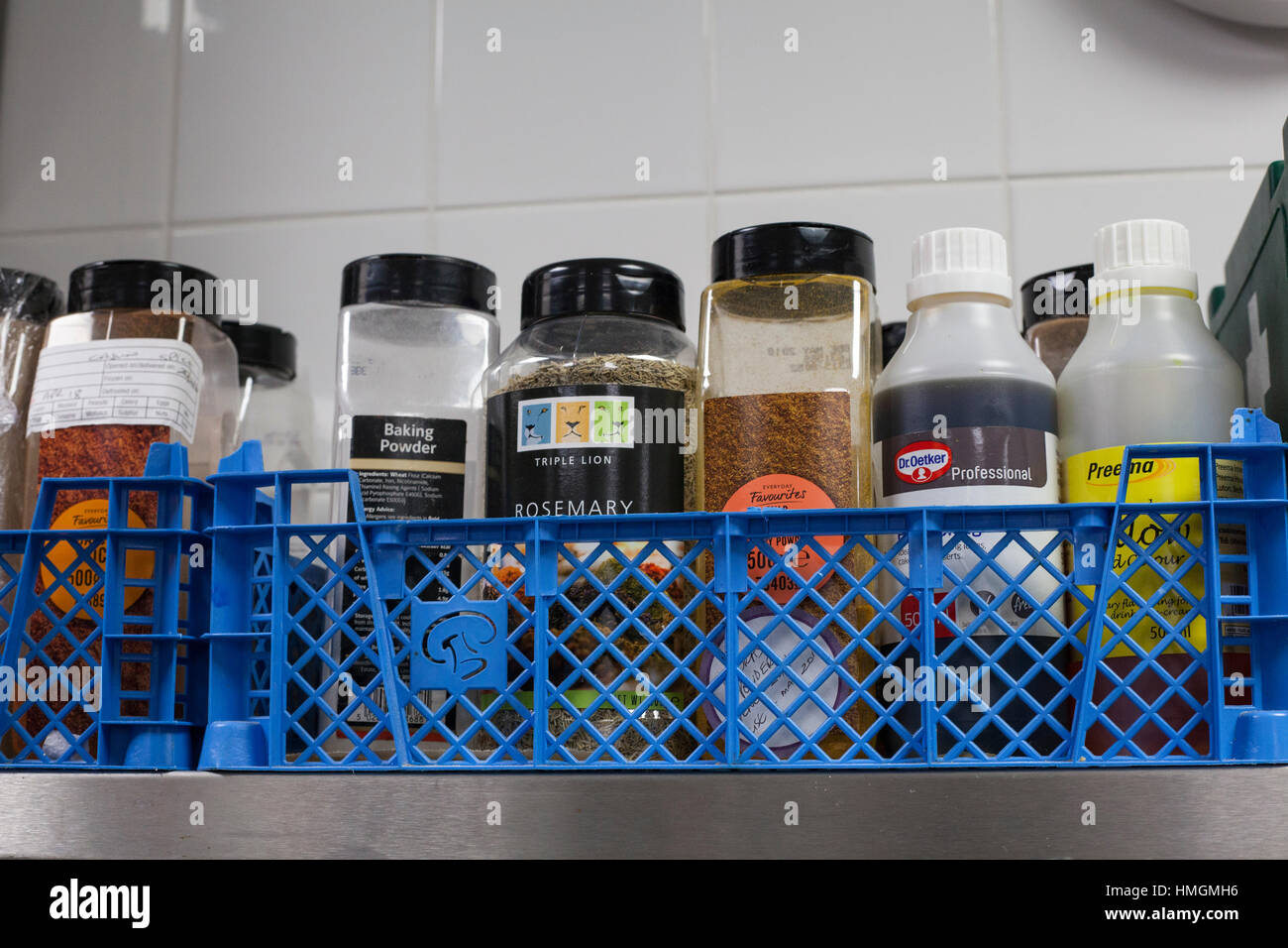 Make shift spice rack, in an industrial kitchen. A mushroom crate used ...