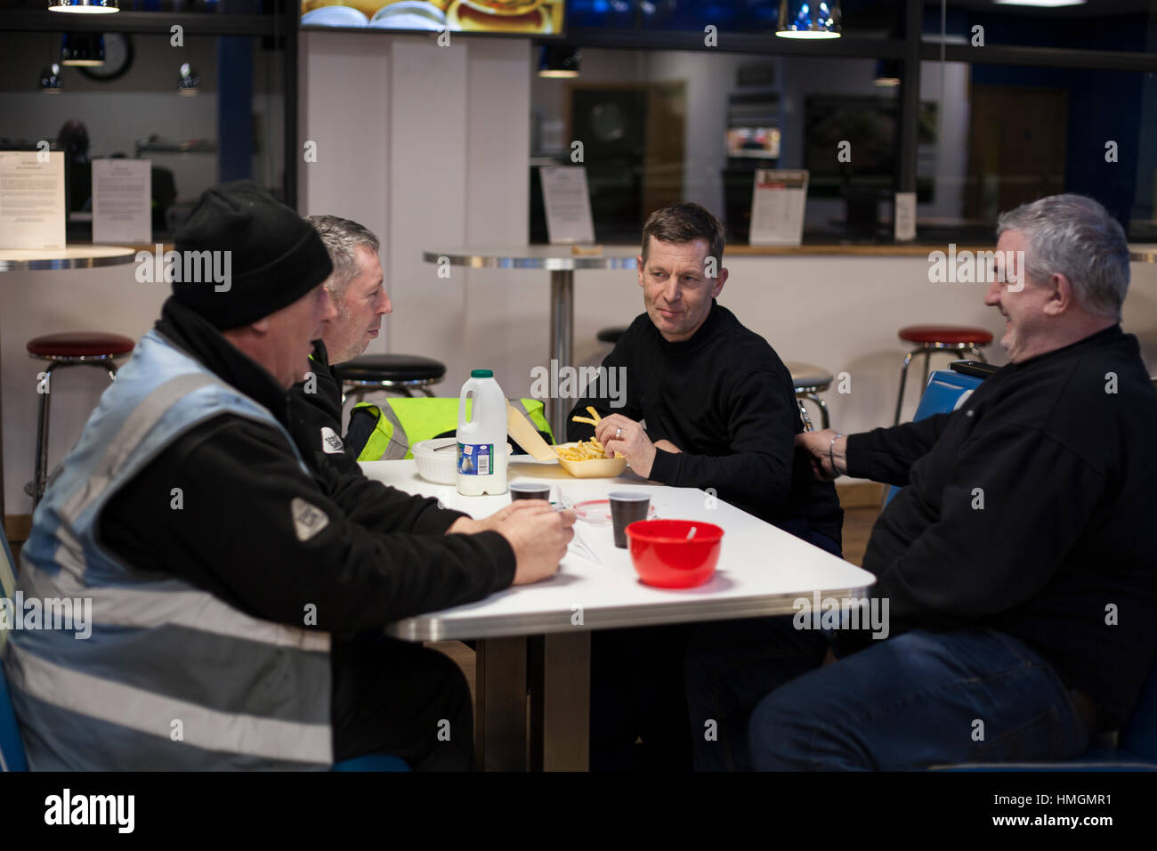 Workers having a break in a staff canteen / cafeteria / cafe Stock ...