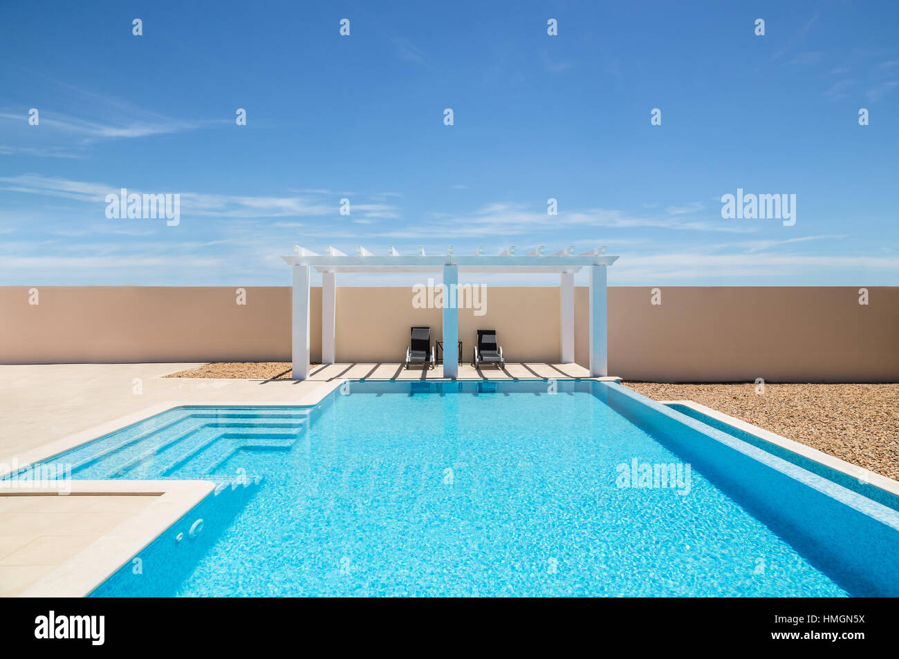 White poolside pergola, gazebo next to an infinity pool swimming pool ...