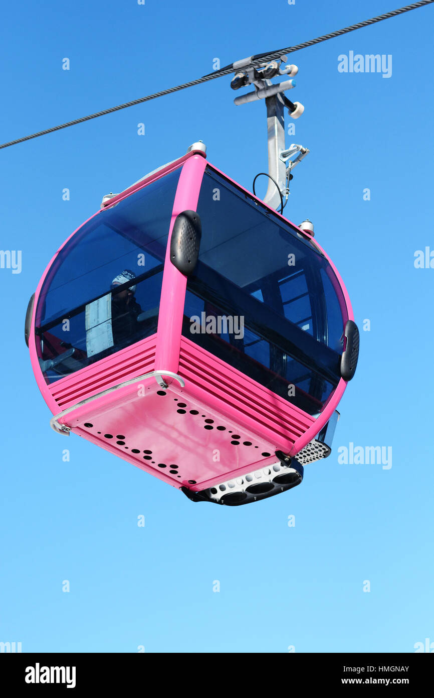 Pink cable car cabin on blue sky as background Stock Photo - Alamy