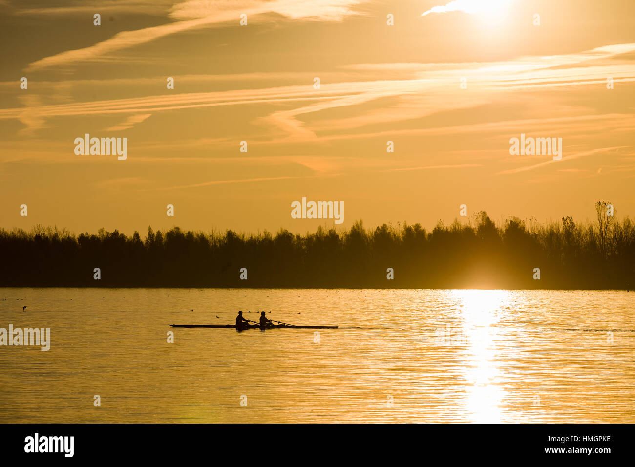 Stock Photo of two rowers on the lake in early morning at sunrise Stock ...
