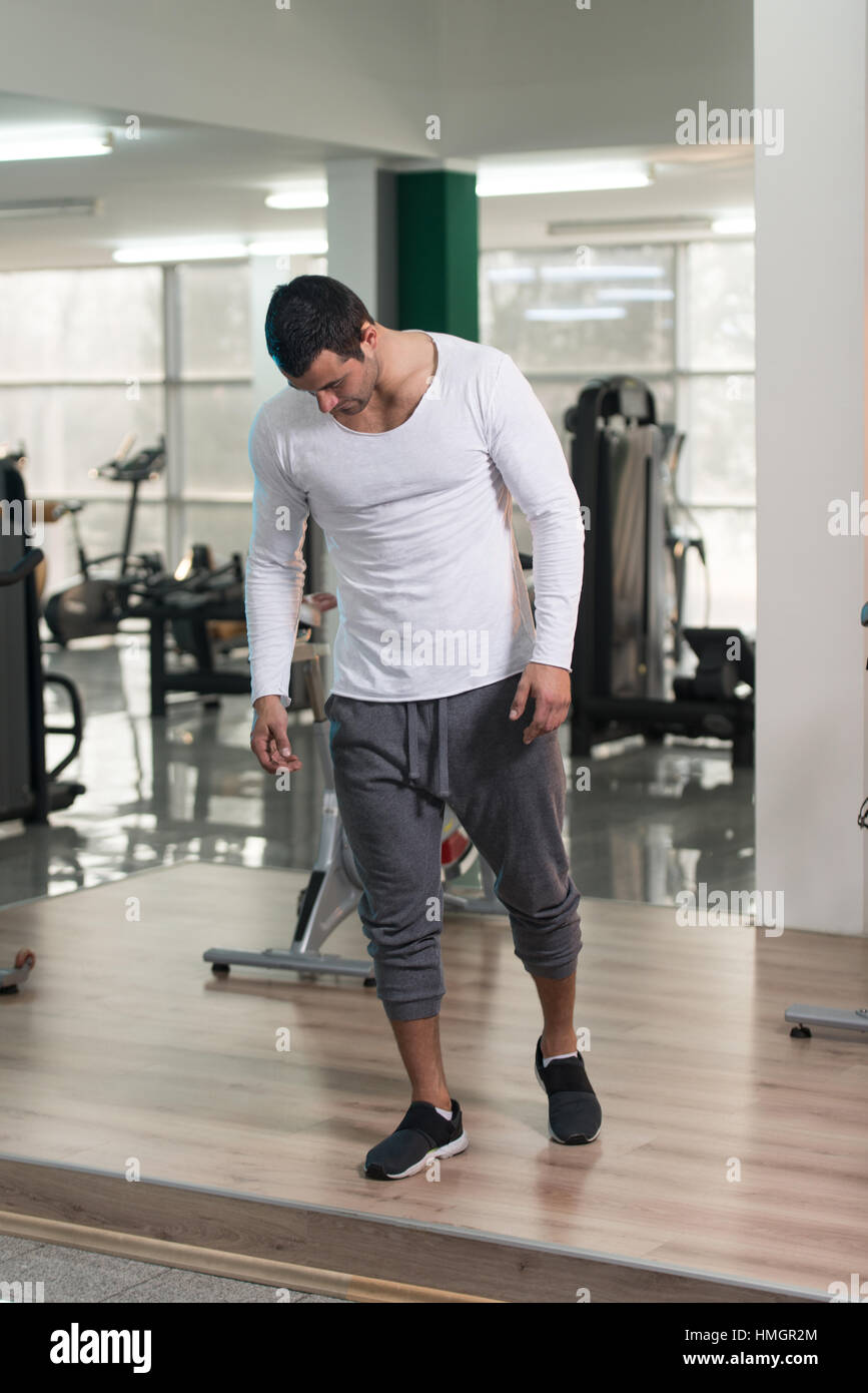 Portrait of a Young Physically Fit Man in White T-shirt Showing His ...