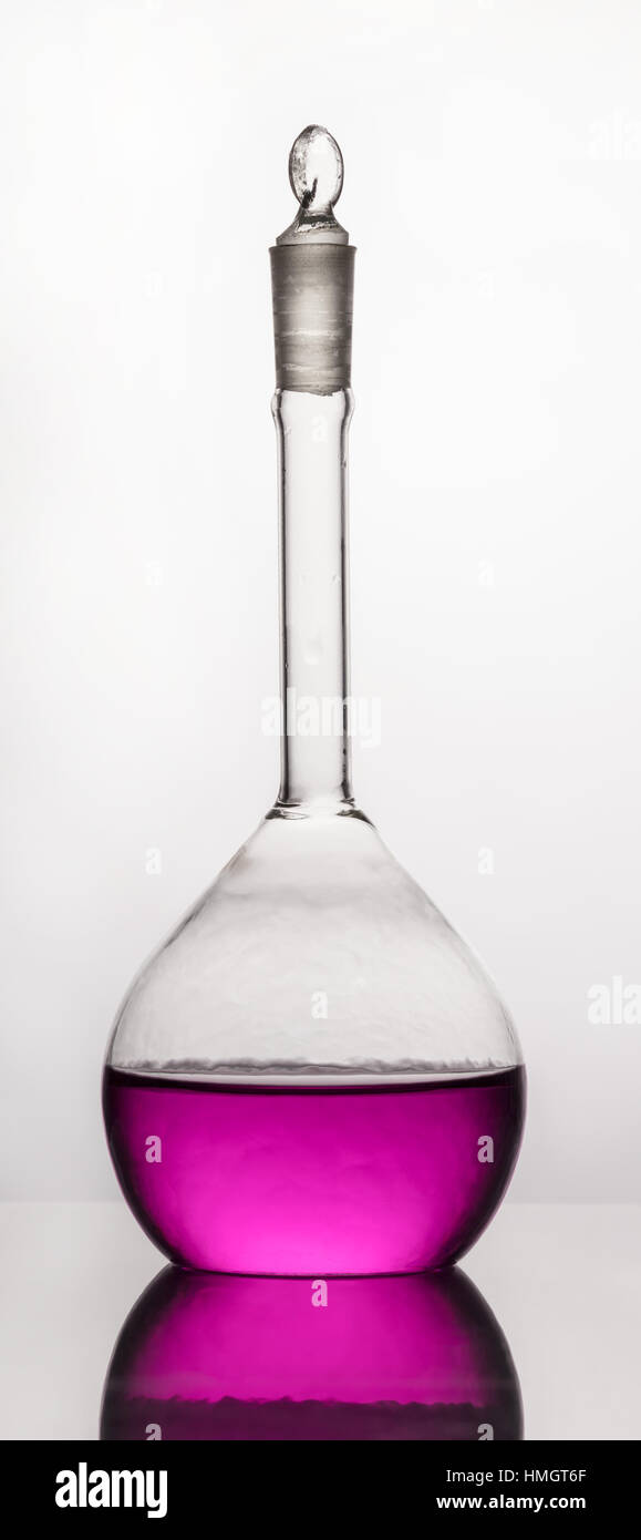 Chemical flask with liquid on a white background Stock Photo - Alamy