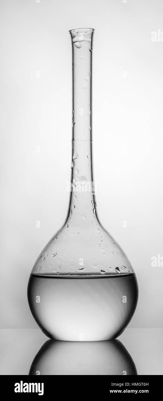 Chemical flask with liquid on a white background Stock Photo - Alamy