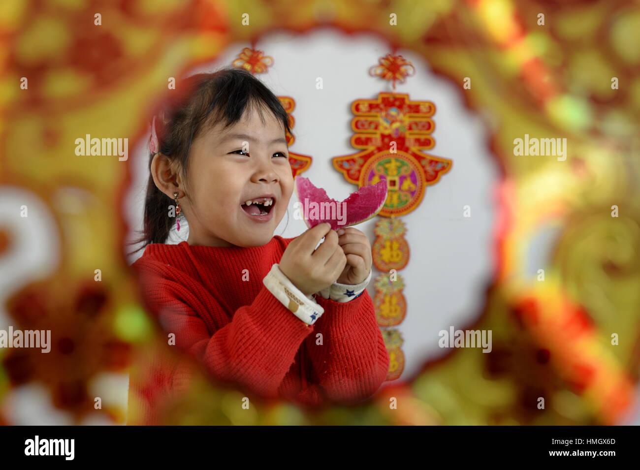 Xingtai, China's Hebei Province. 3rd Feb, 2017. A young girl eats ...