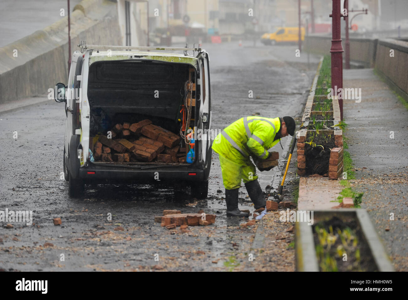 Seaton, Devon, UK. 3rd February 2017. UK Weather. A workman clearing up ...