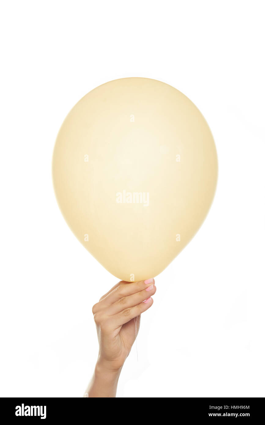 woman hand holding yellow balloon on white background Stock Photo - Alamy
