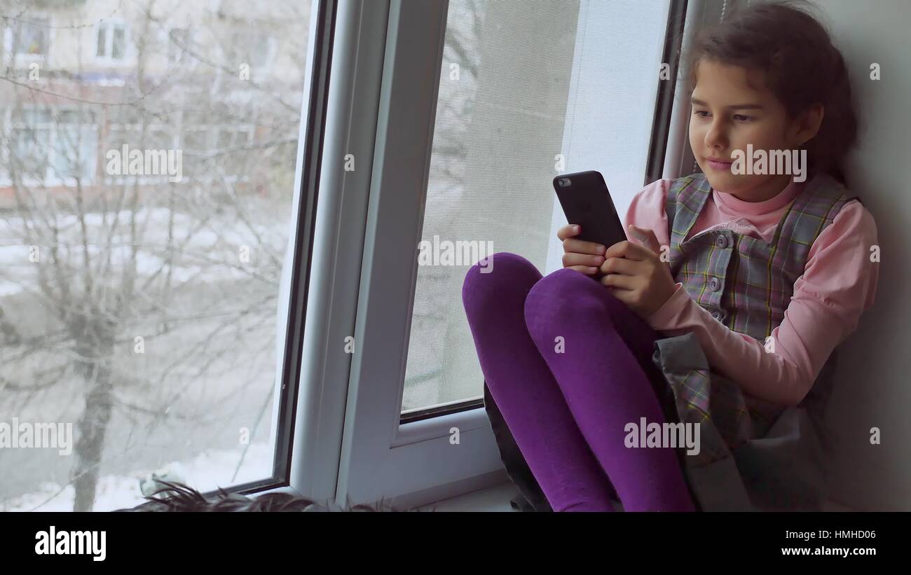 girl teen playing online the game for smartphone and pet dog sitting on ...