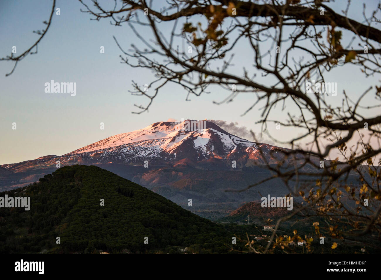 Sunset on Mount Etna through trees Stock Photo - Alamy