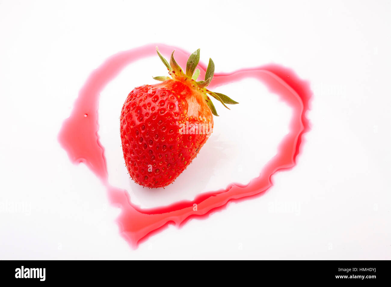 closeup studio photo of one strawberrie inside shinny heart from ...