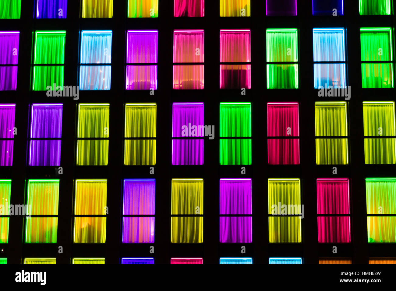 Colored windows texture. Windows illuminated by neon lights background ...