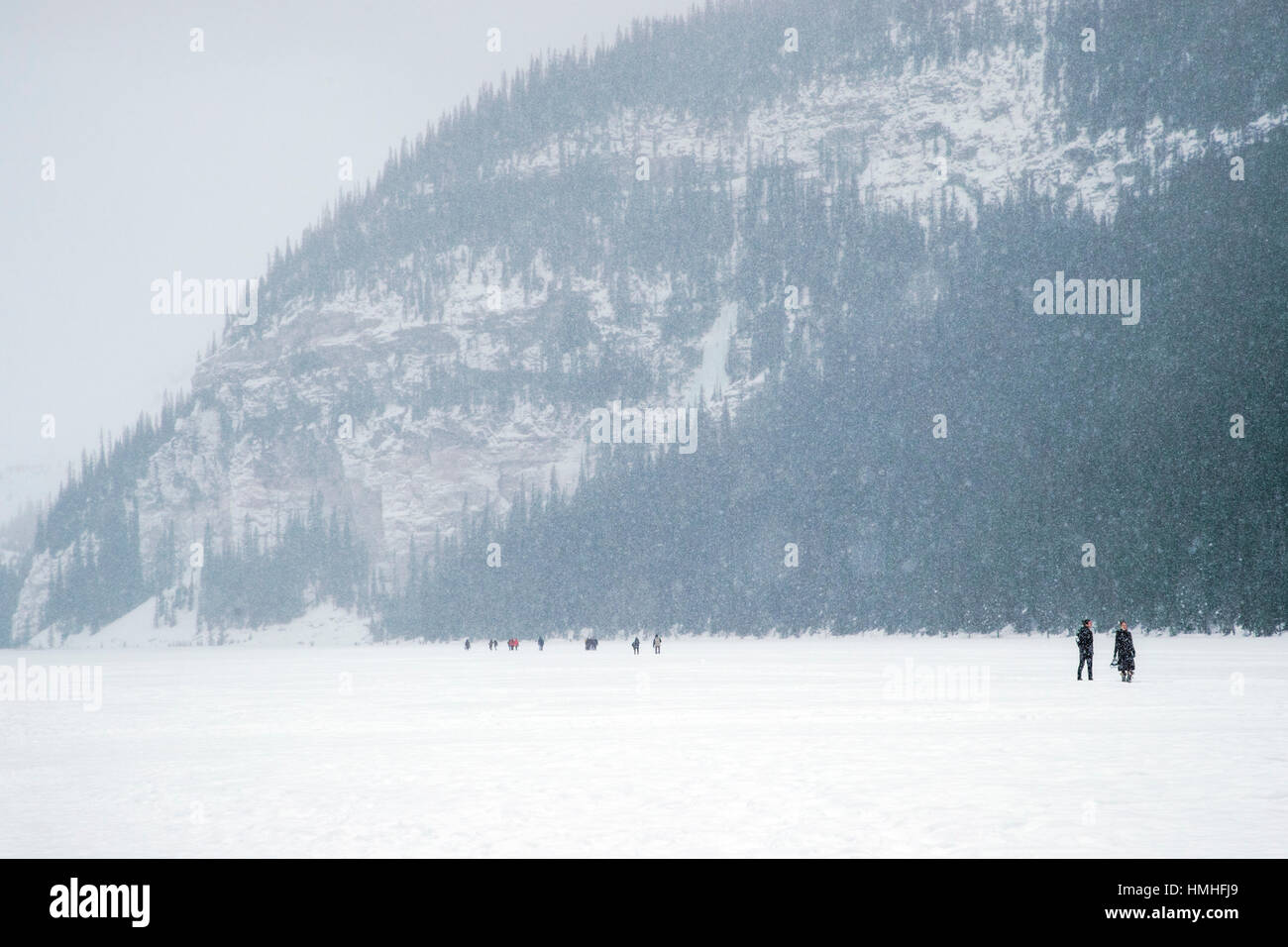 Tourists ice skating on Lake Louise; The Fairmont Lake Louise; Lake ...