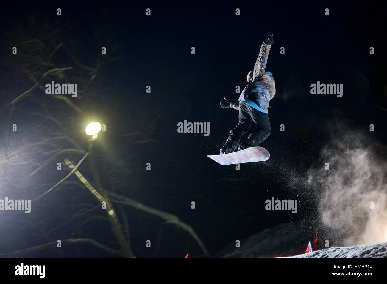 Snowboarder jumping at night Stock Photo - Alamy