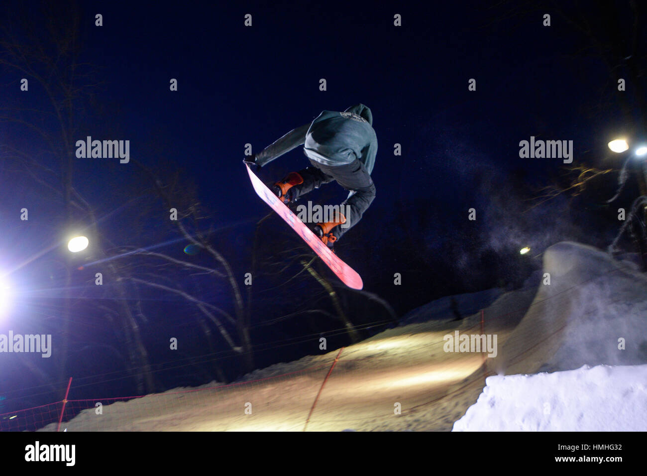 Snowboarder jumping at night Stock Photo - Alamy