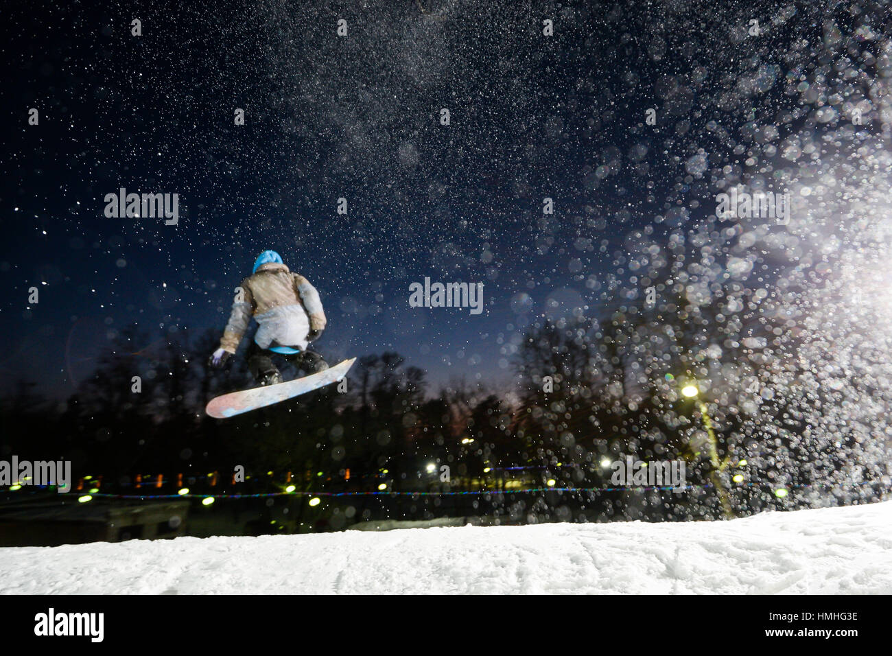 Snowboarder jumping at night Stock Photo - Alamy