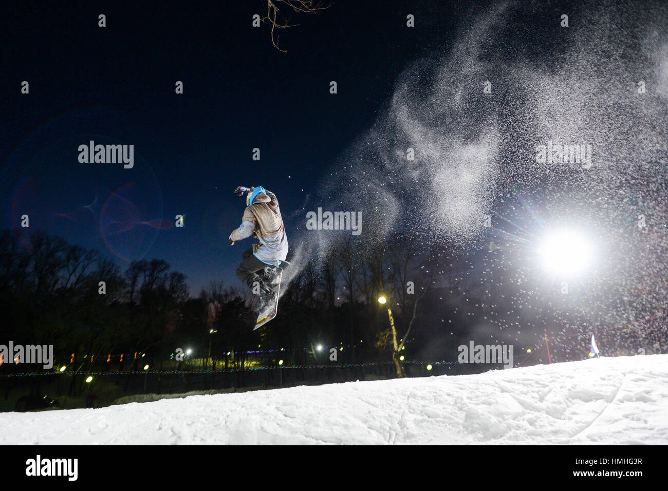 Snowboarder jumping at night Stock Photo - Alamy