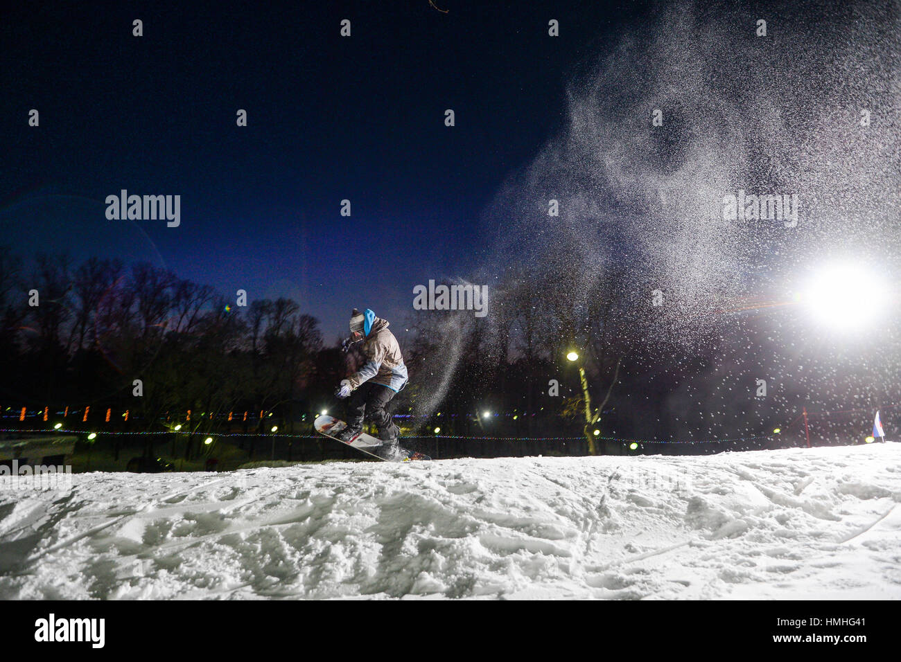 Snowboarder jumping at night Stock Photo - Alamy
