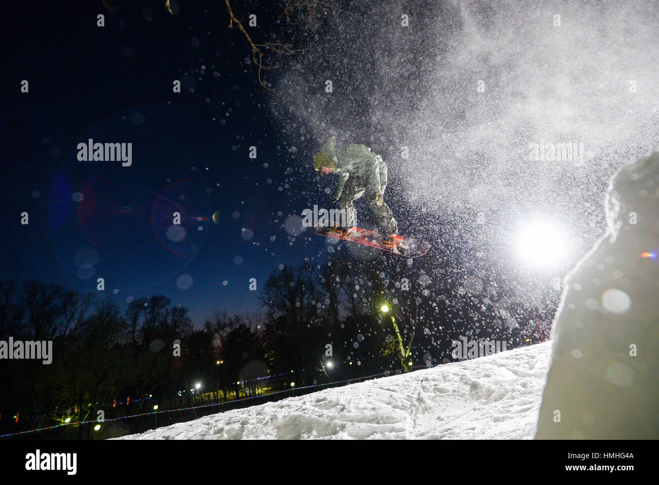 Snowboarder jumping at night Stock Photo - Alamy