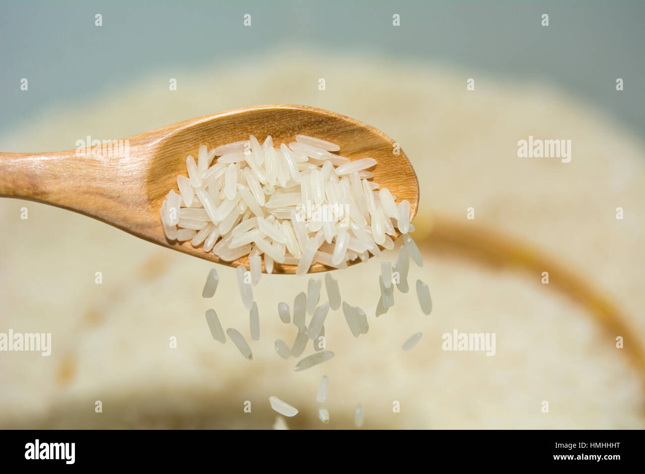 Pouring thai jasmine rice from wooden spoon Stock Photo - Alamy