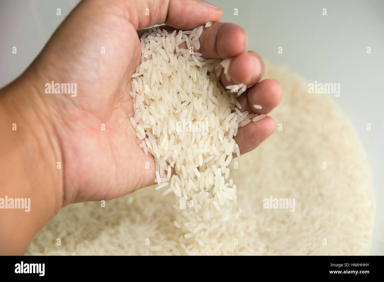 Hand pouring rice hi-res stock photography and images - Alamy