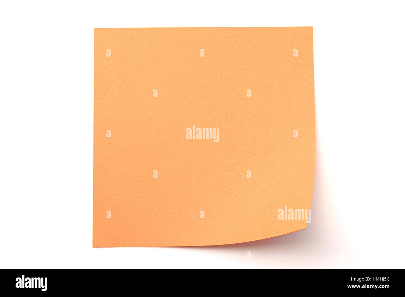 Orange paper stick note on a white background Stock Photo - Alamy