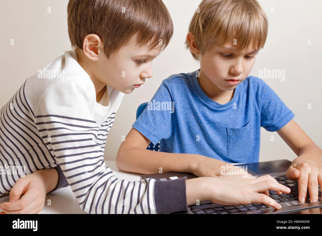 Kids with laptop computer. Interested boys using PC, looking at screen ...