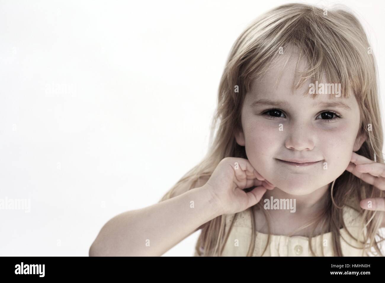 Little girl with a gentle sweet smile in sepia Stock Photo - Alamy