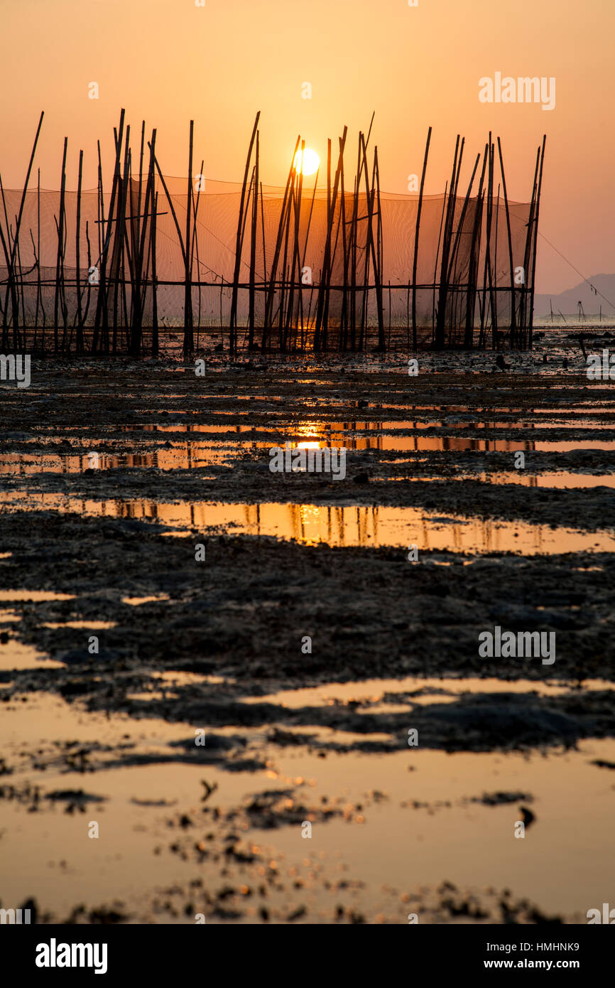 Tide fishing nets at sunset. Thailand Stock Photo - Alamy