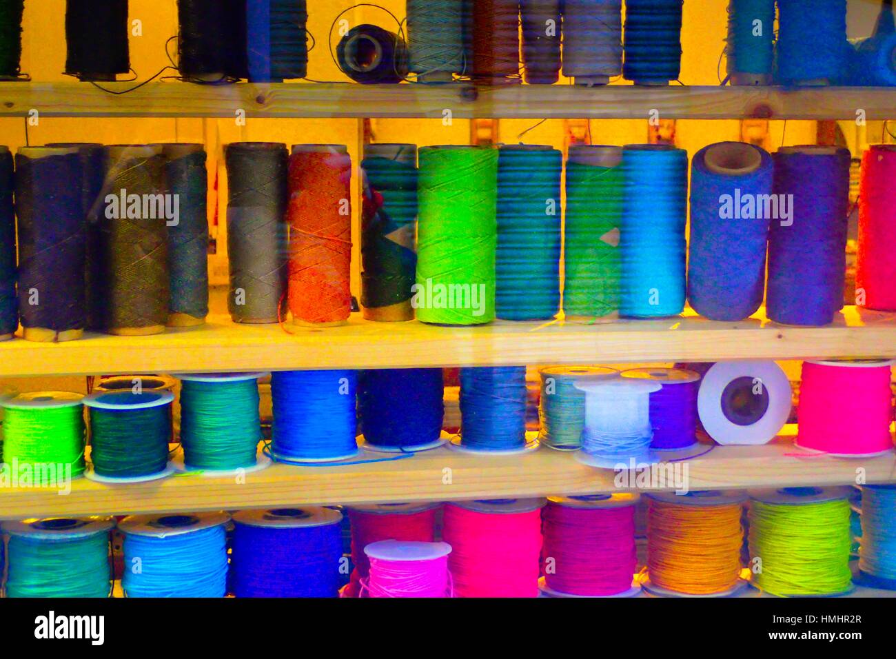 Several rolls of different colored thread Stock Photo - Alamy