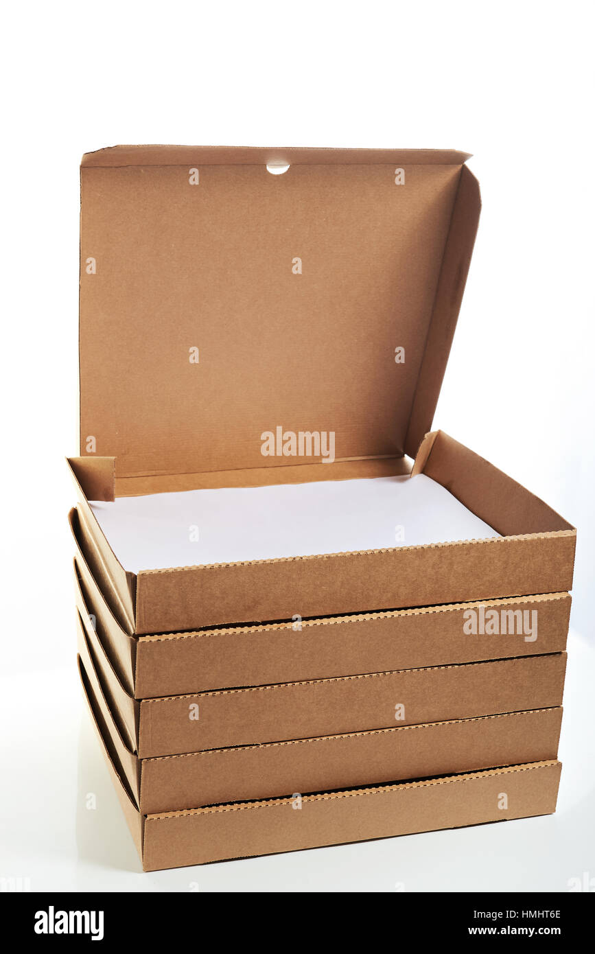 open brown pizza box on top of pile isolated on white Stock Photo - Alamy