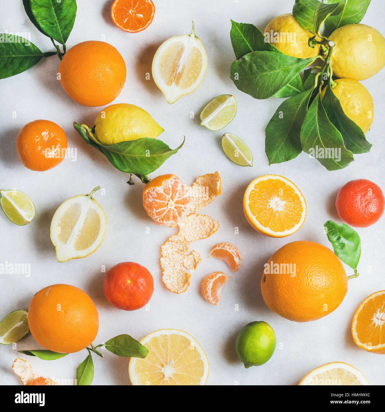 Variety of fresh citrus fruit over light grey marble background Stock ...