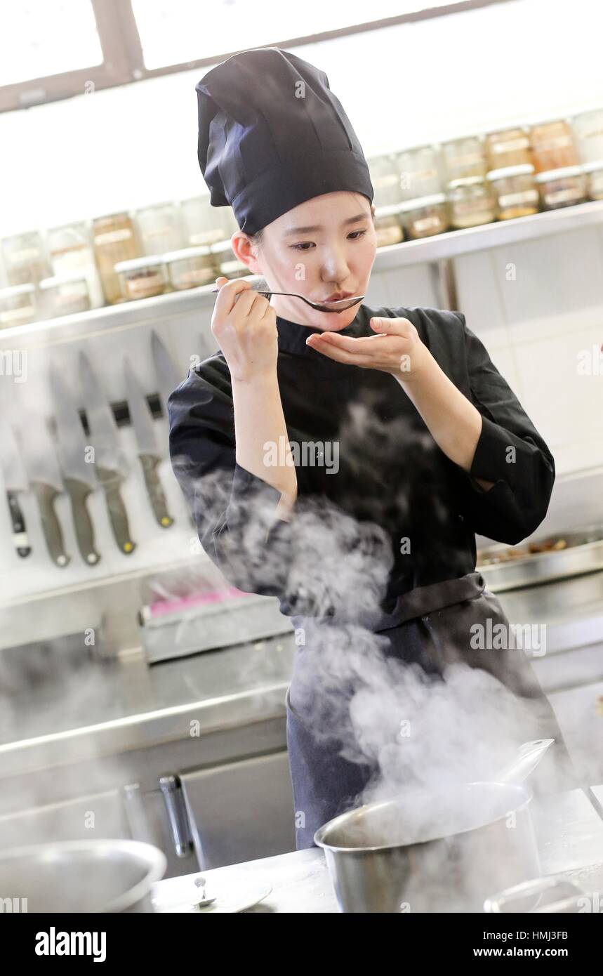 Chef tasting food in restaurant kitchen Stock Photo - Alamy