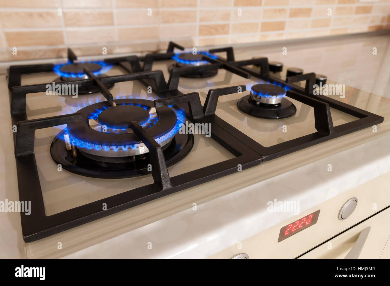 Closeup shot of blue fire from domestic kitchen stove. Gas cooker with ...