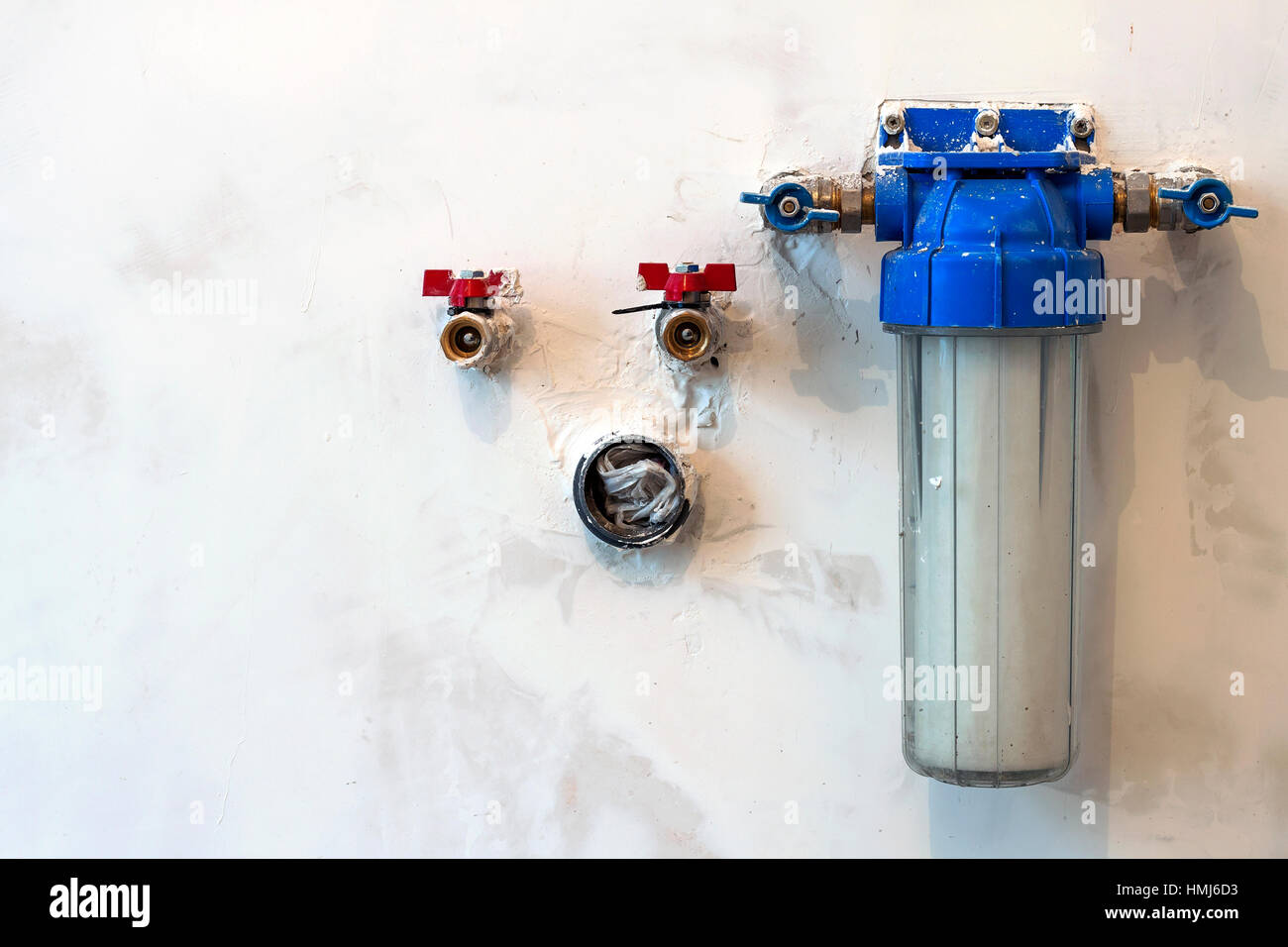 Water filter new installed on a kitchen wall to purify drinking water ...