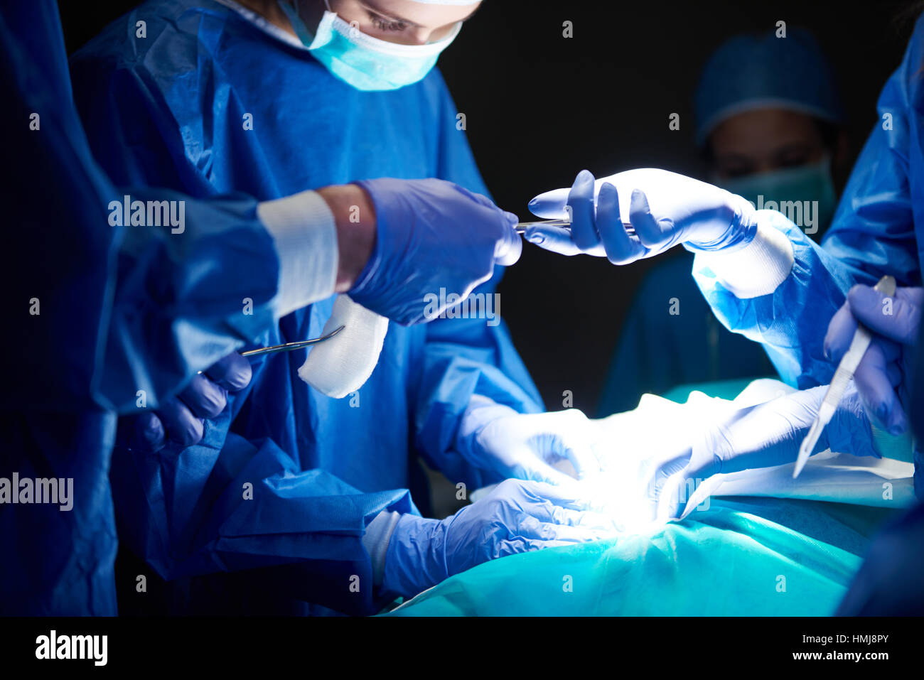 Surgeons passing scissors to each other Stock Photo - Alamy