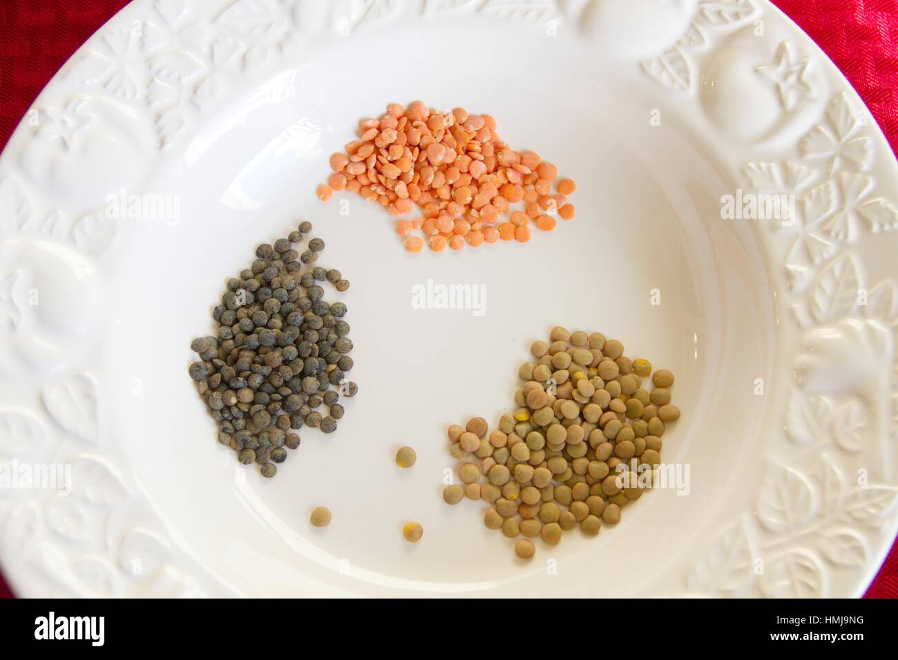 Different lentil varieties in a white bowl Stock Photo - Alamy