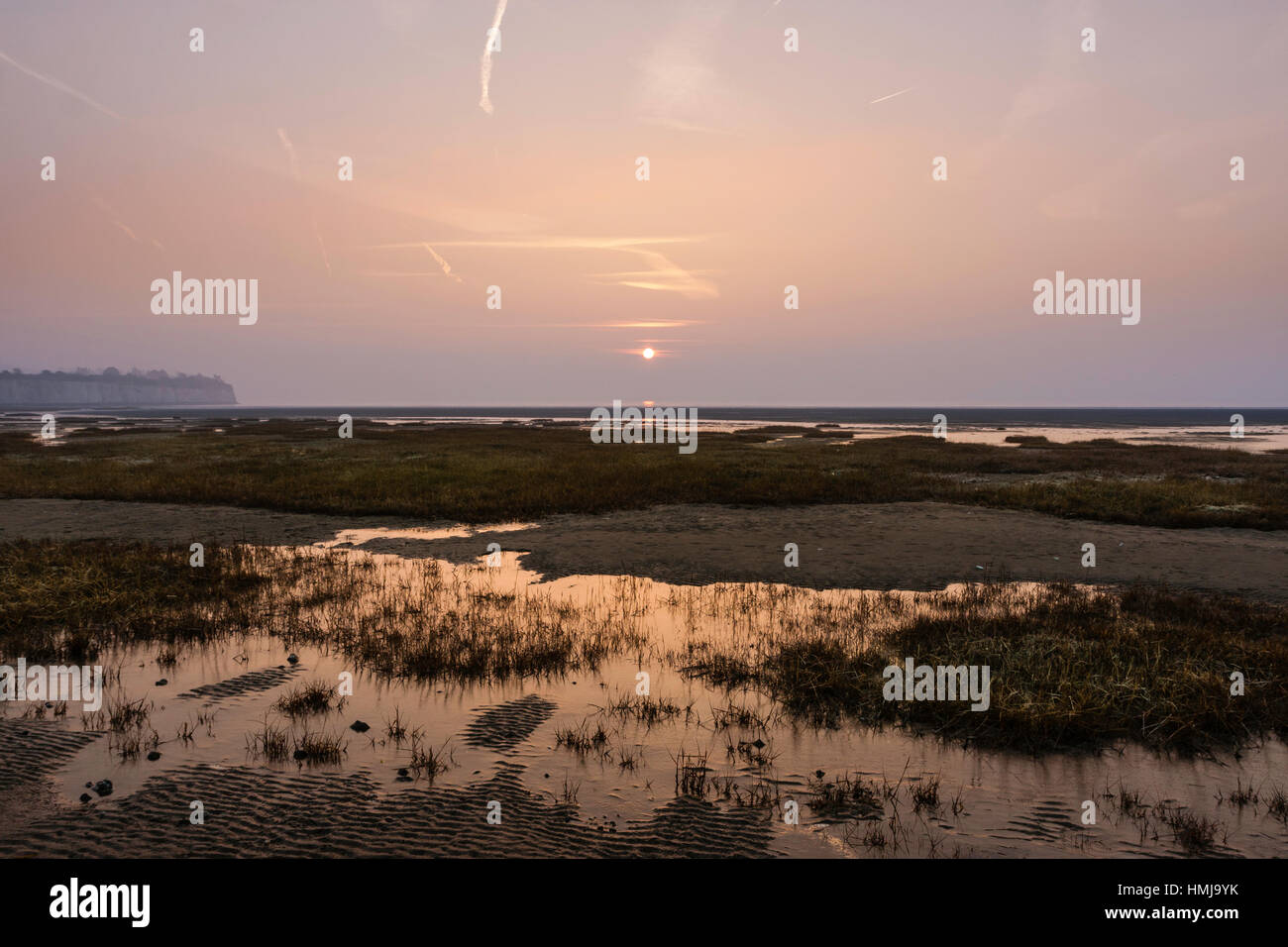 Sunrise over the English Channel at Pegwell Bay. Salt water marshes at ...