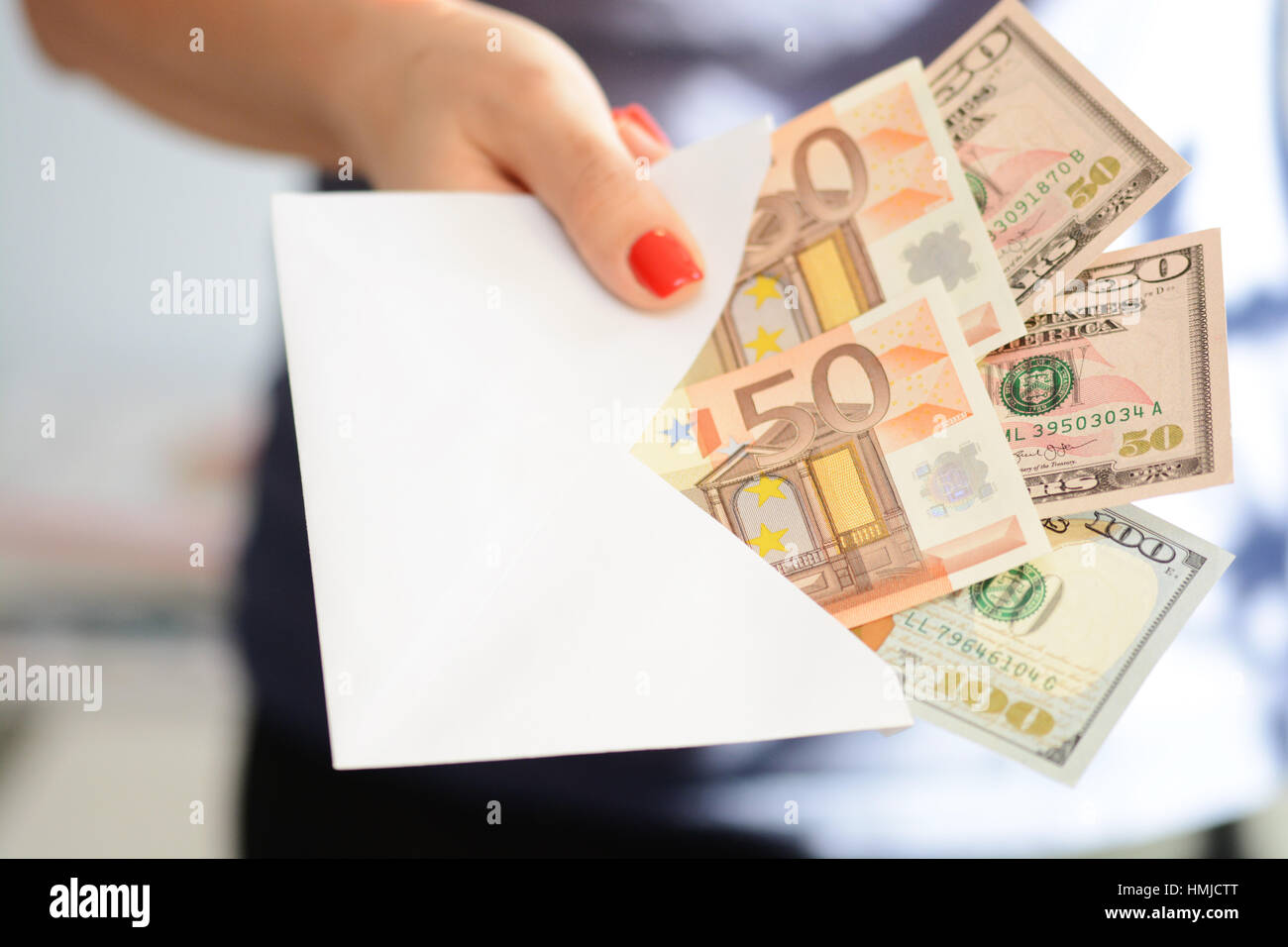 Woman handing out envelope hi-res stock photography and images - Alamy