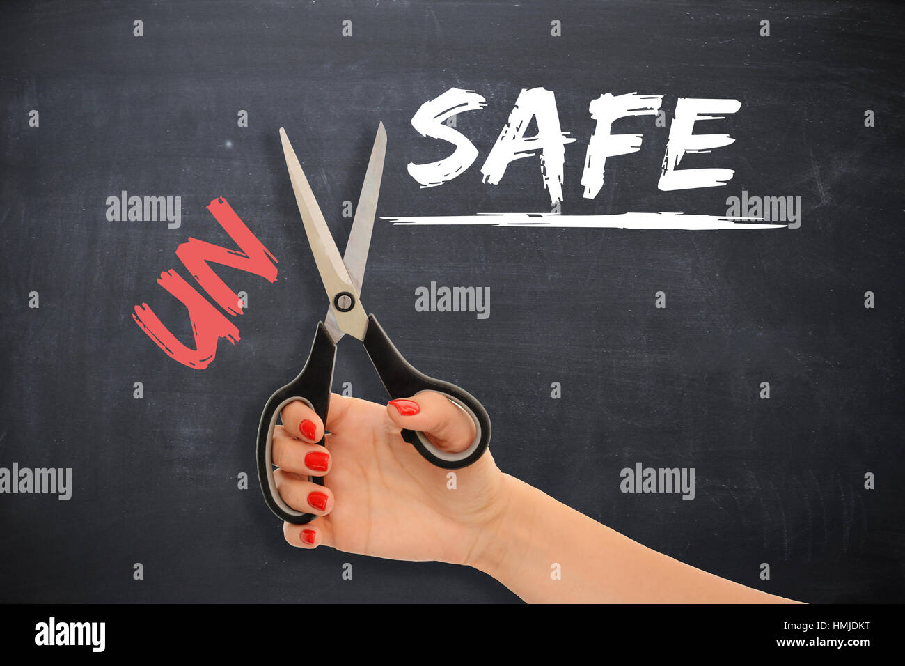 Woman transforming the word “unsafe” into “safe” with scissors Stock ...