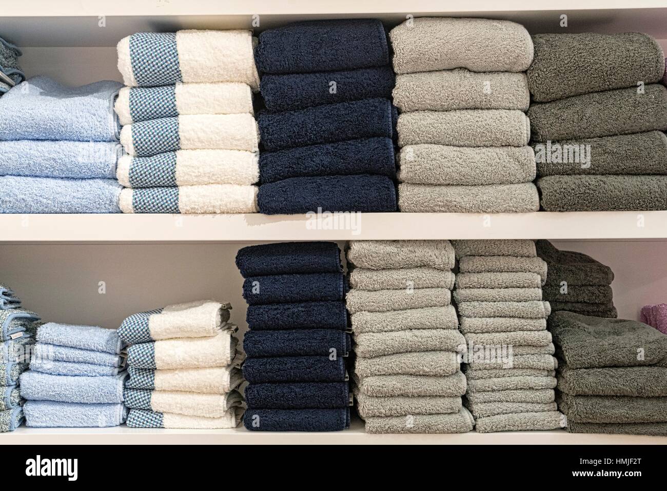 Two Shelves Full of Stacked Towels of Many Colors. Displayed and ...