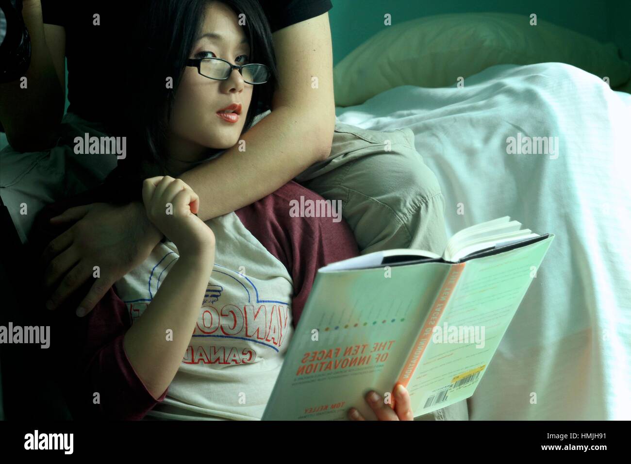 boyfriend embracing girlfriend at the edge of the bed Stock Photo - Alamy