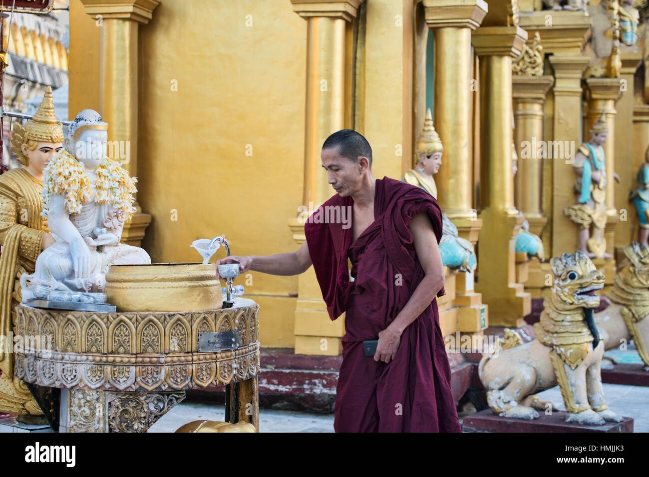 Monk praying at Shwedagon Paya, the holiest site in Yangon, Myanmar ...