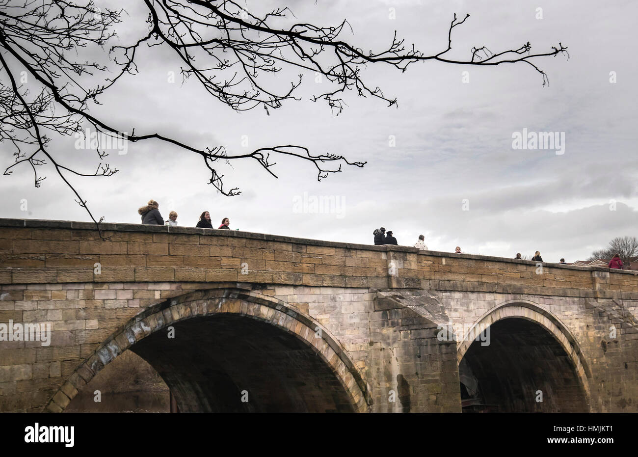 Members of the public cross Tadcaster Bridge as it reopens more than a ...
