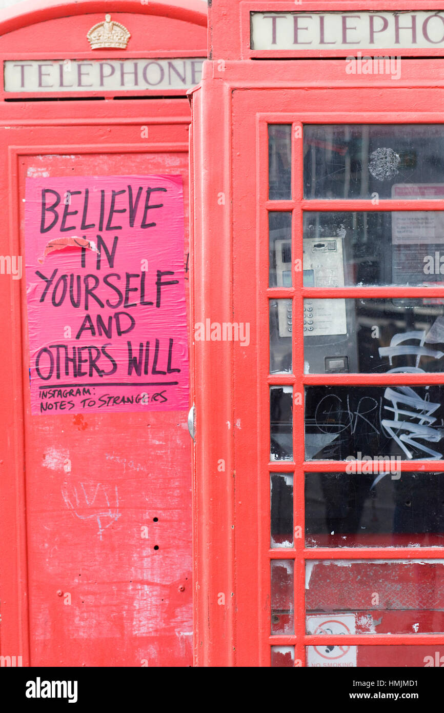 Telephone box with a notice saying "Believe in yourself and others will ...