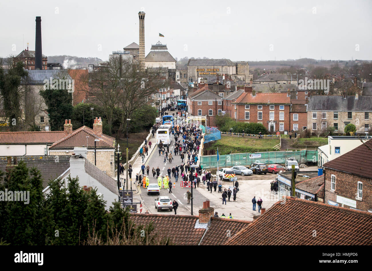 Members of the public cross Tadcaster Bridge as it reopens more than a ...